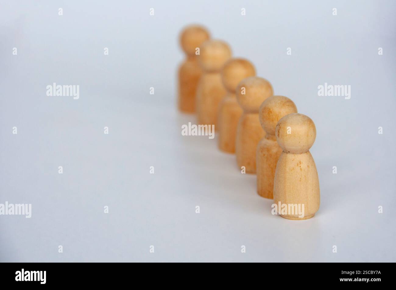 A wooden figure leading other wooden figures with customizable space ...
