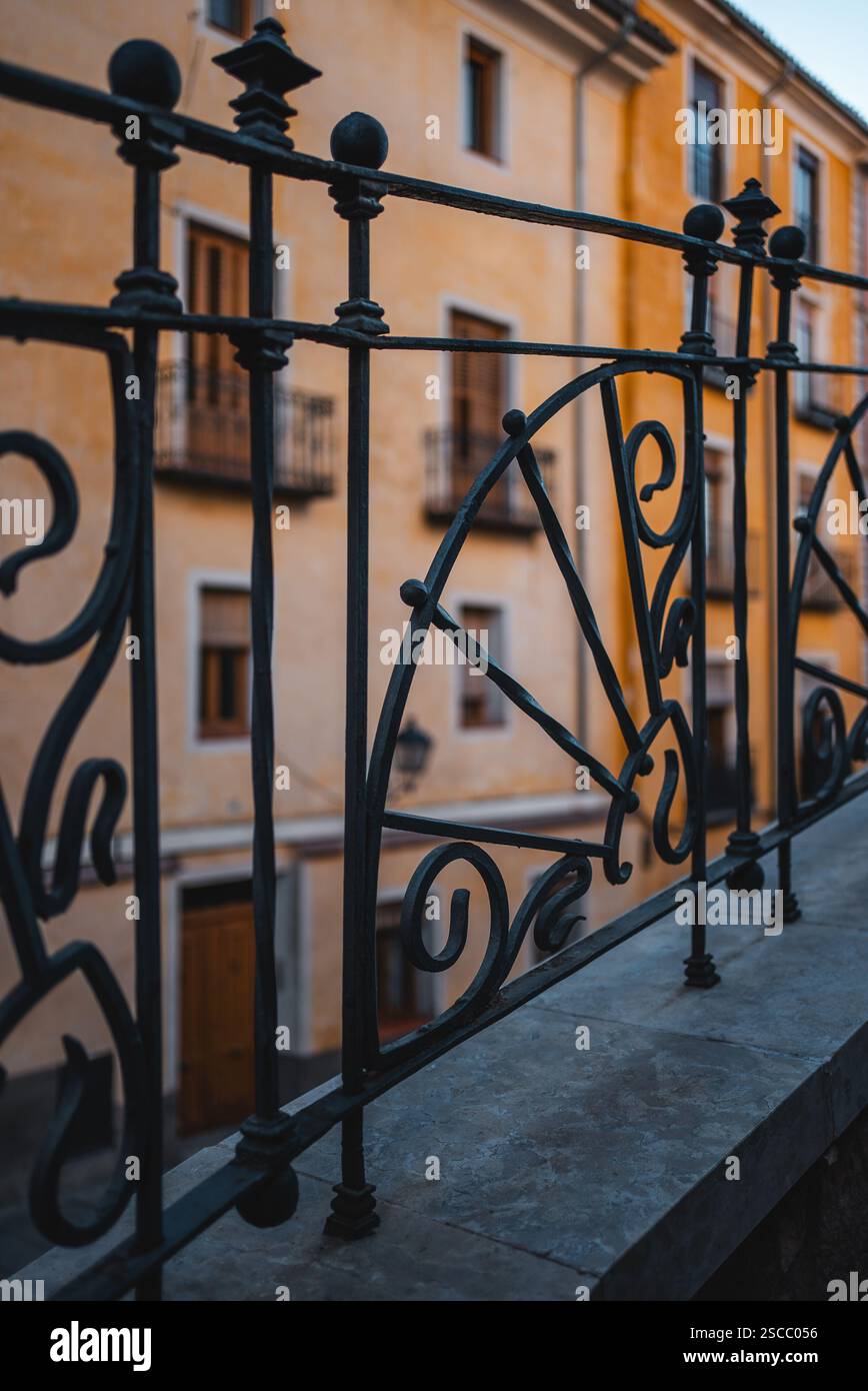 Intricate ironwork adorns the balcony railing, framing the view ...
