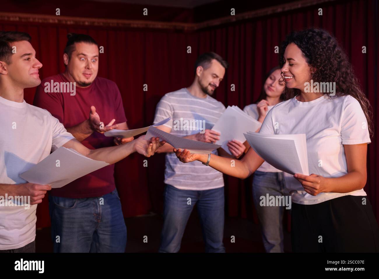 Professional actors with their scripts rehearsing in theatre Stock ...