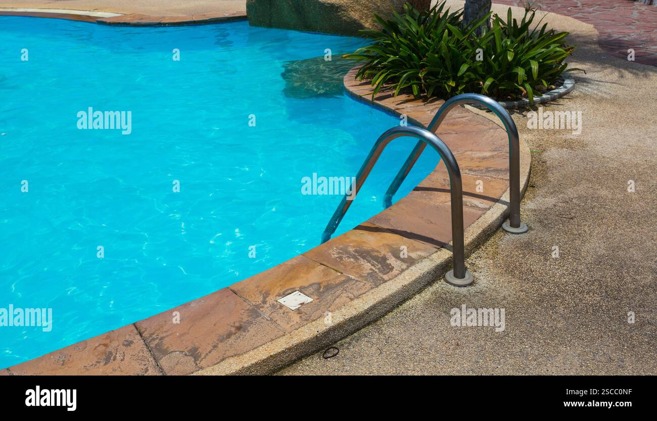 Grab bars ladder in the blue swimming pool Stock Photo - Alamy