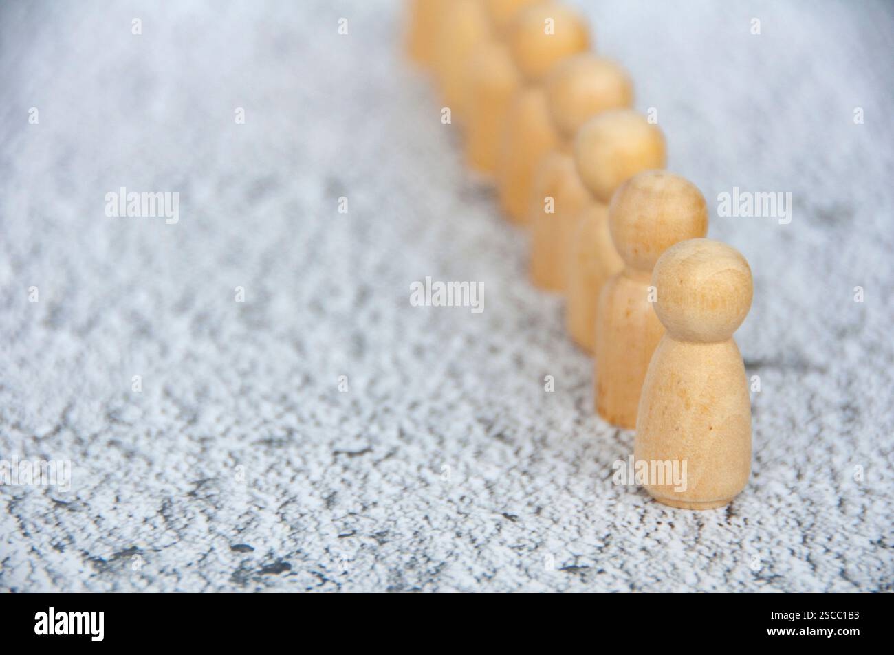 A wooden figure leading other wooden figures with customizable space ...