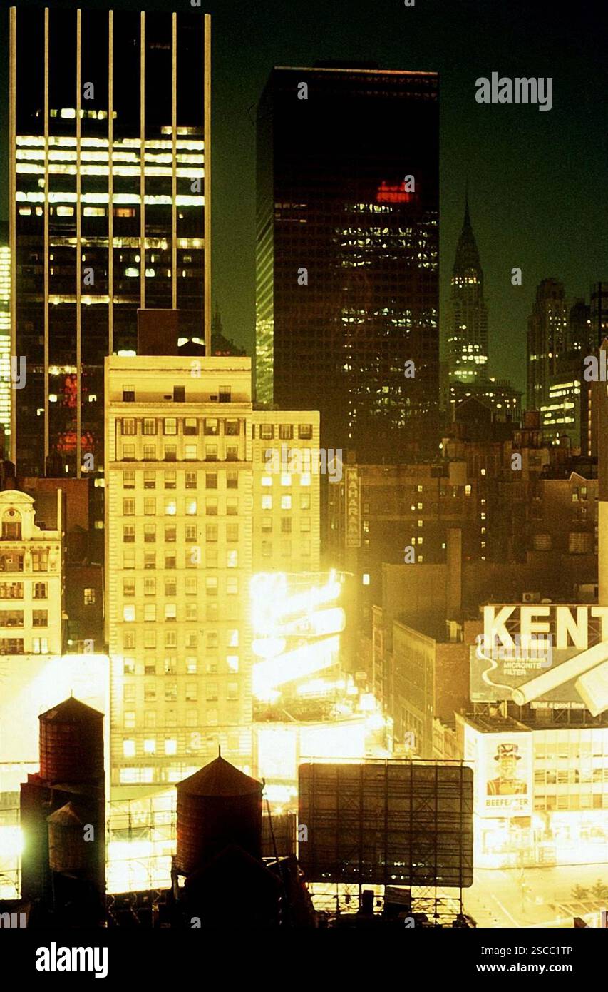 The facades of New York City's skyscrapers are illuminated at night by ...