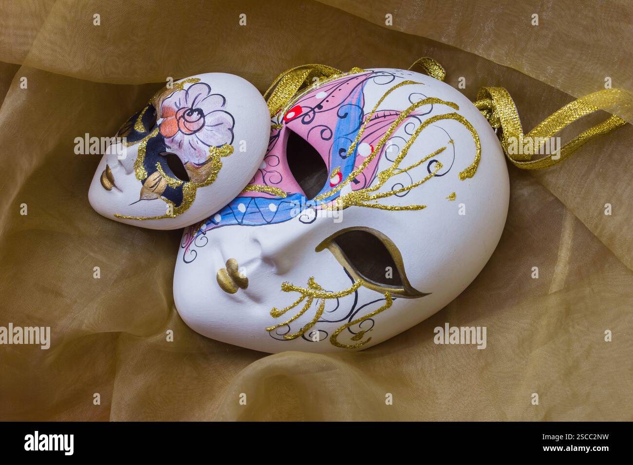 Venetian mask on the background of draping of organza Stock Photo - Alamy