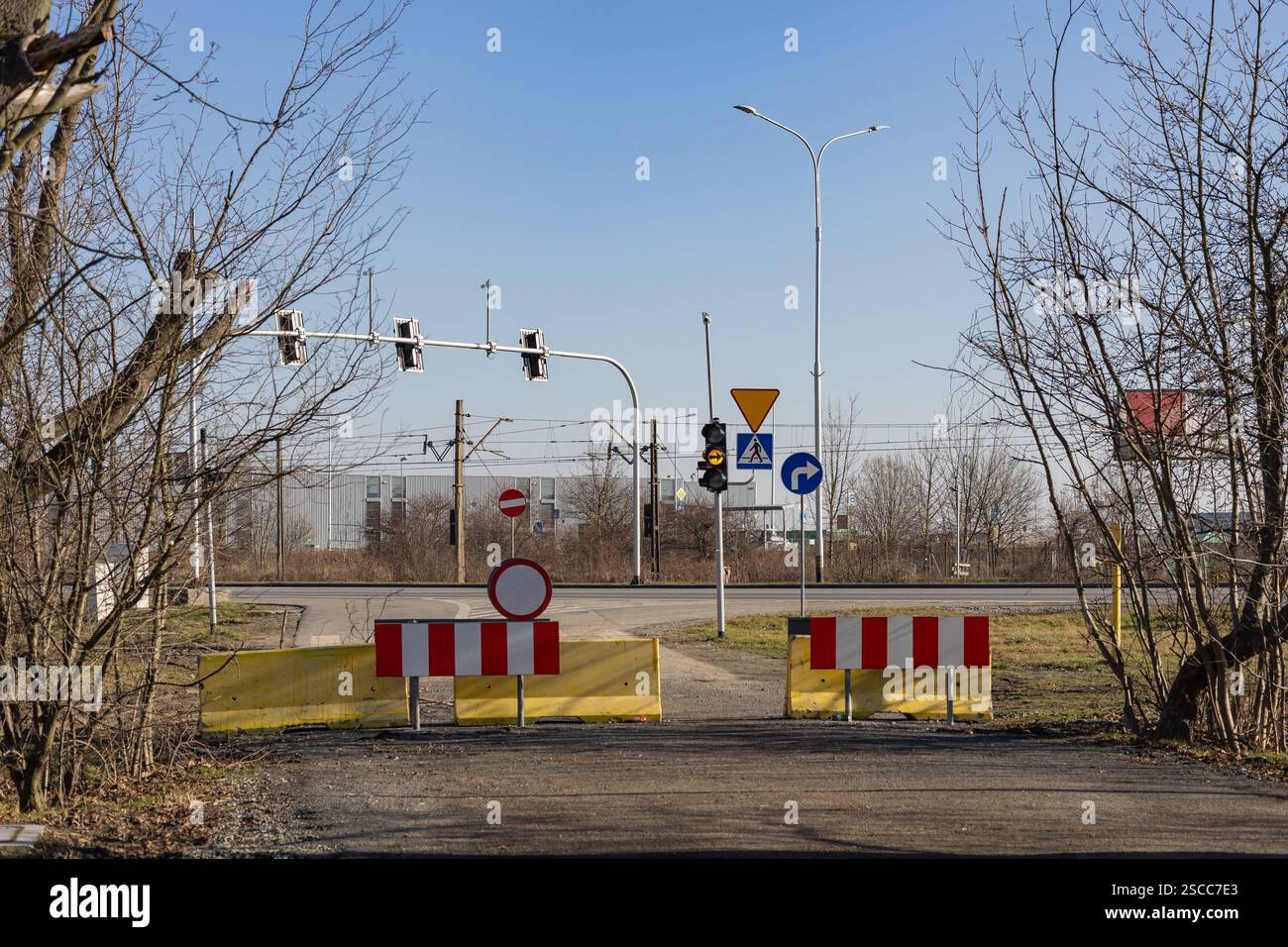 Road closed with barricades, traffic signs and a traffic light at an ...