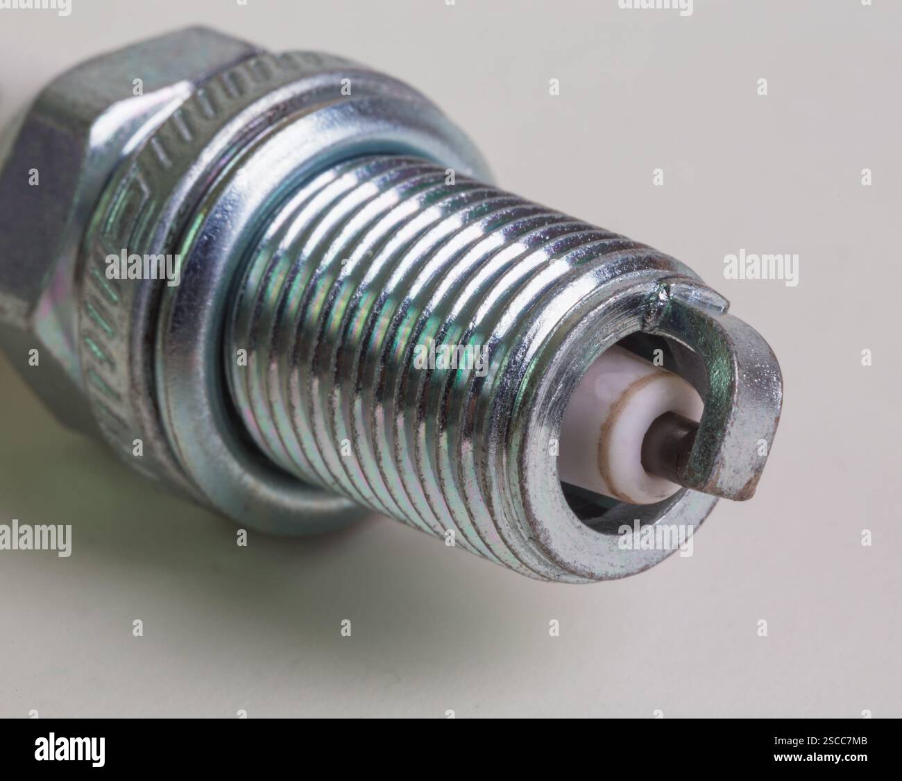 The sparking plug on a white background Stock Photo - Alamy