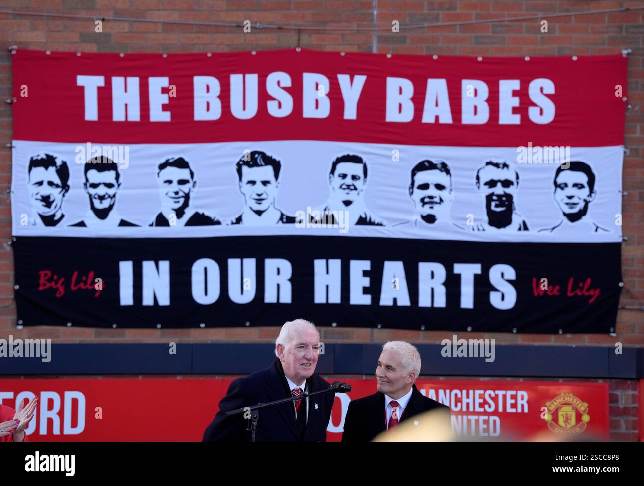 Alex Stepney (left) in front of a Busby Babes flag during the memorial ...