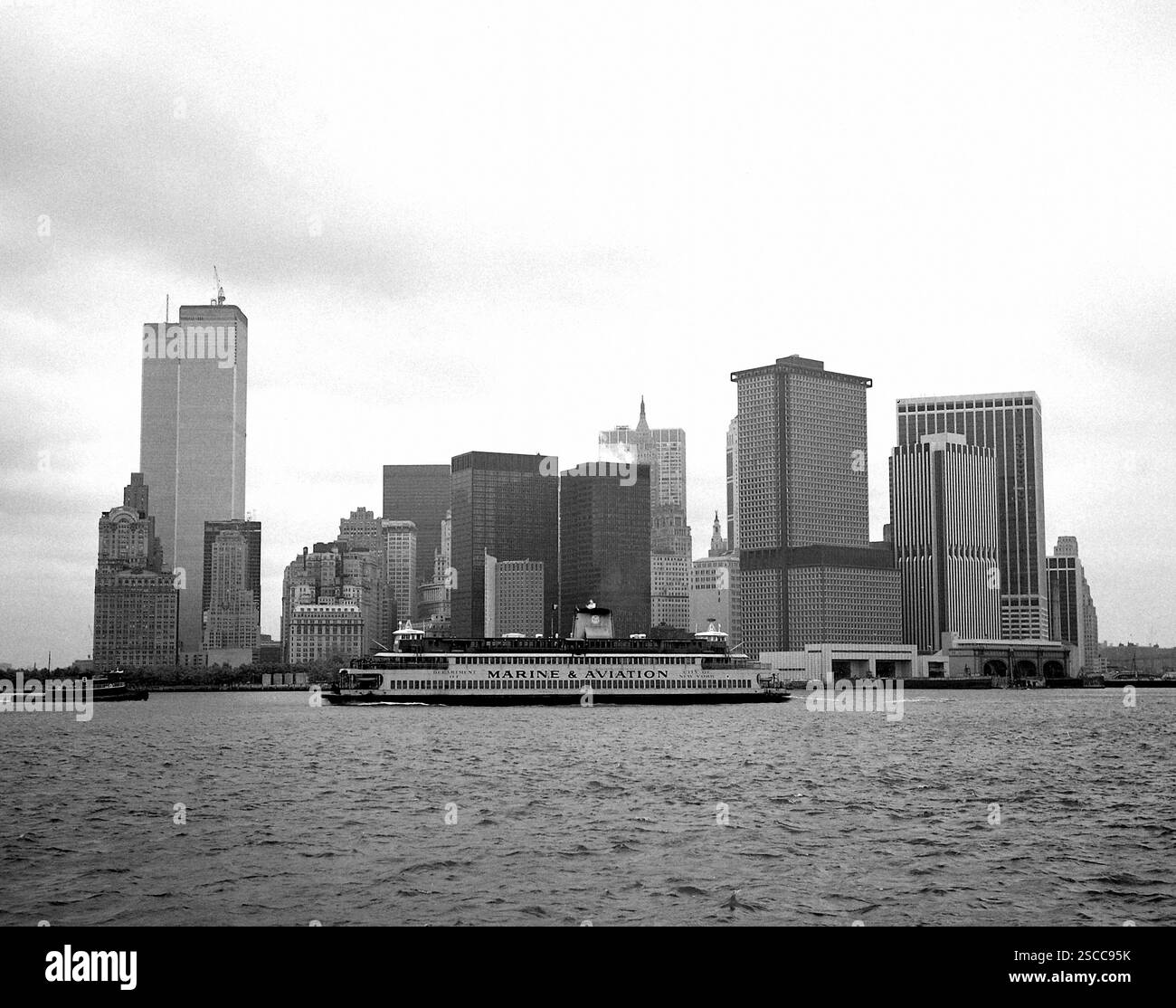 A ferry on the water in front of the high-rise buildings of southern ...