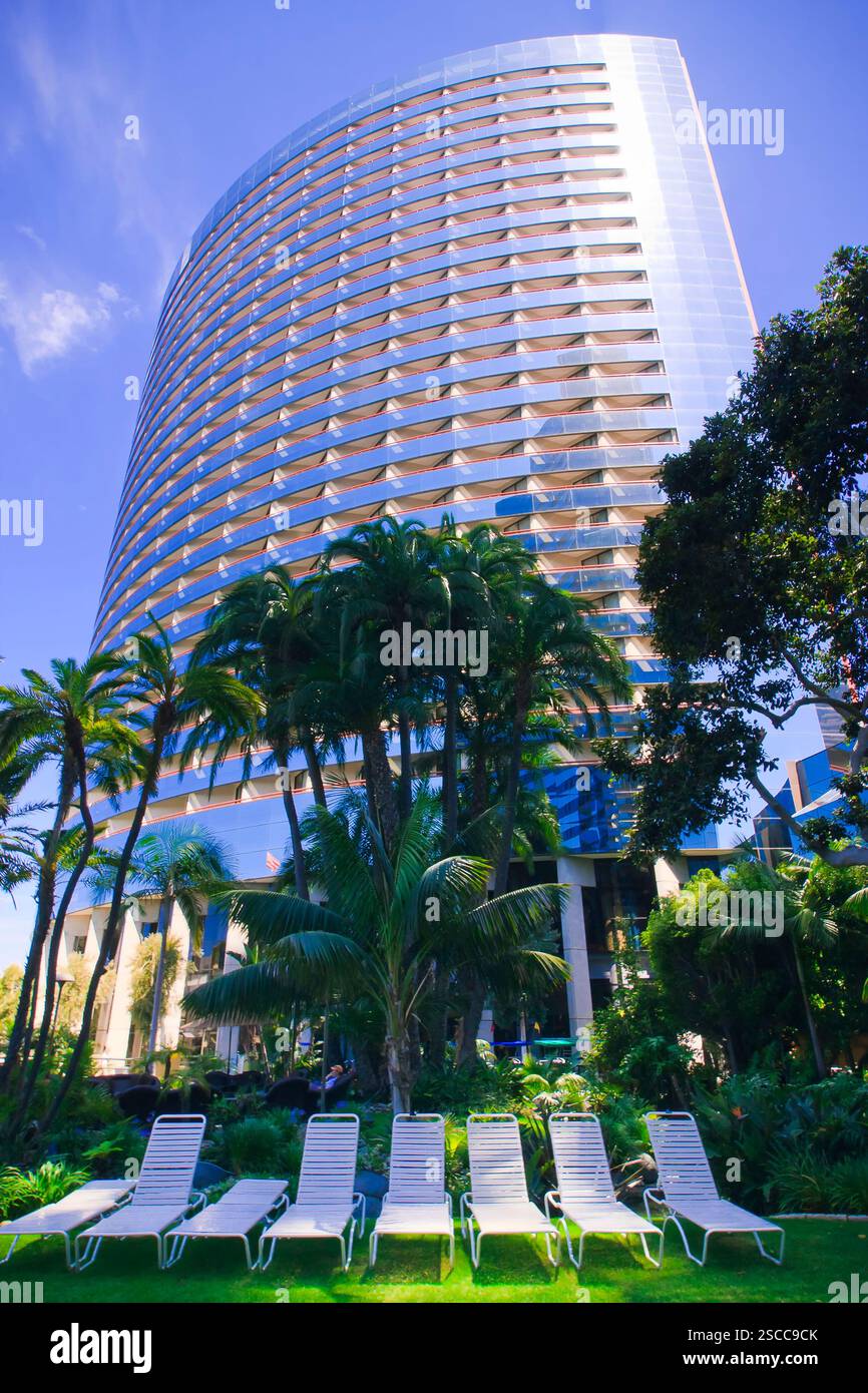 Large building with a lot of windows and a green lawn with several ...