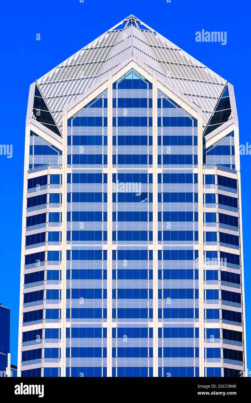 Tall building with a blue roof and a white facade. The building is very ...