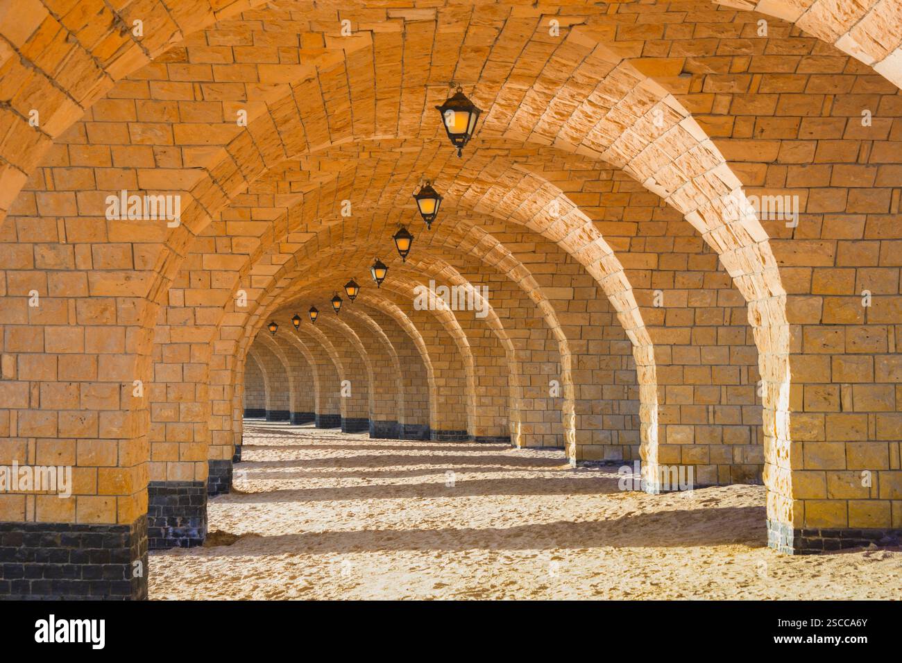 The arched stone colonnade with suspended lanterns Stock Photo - Alamy