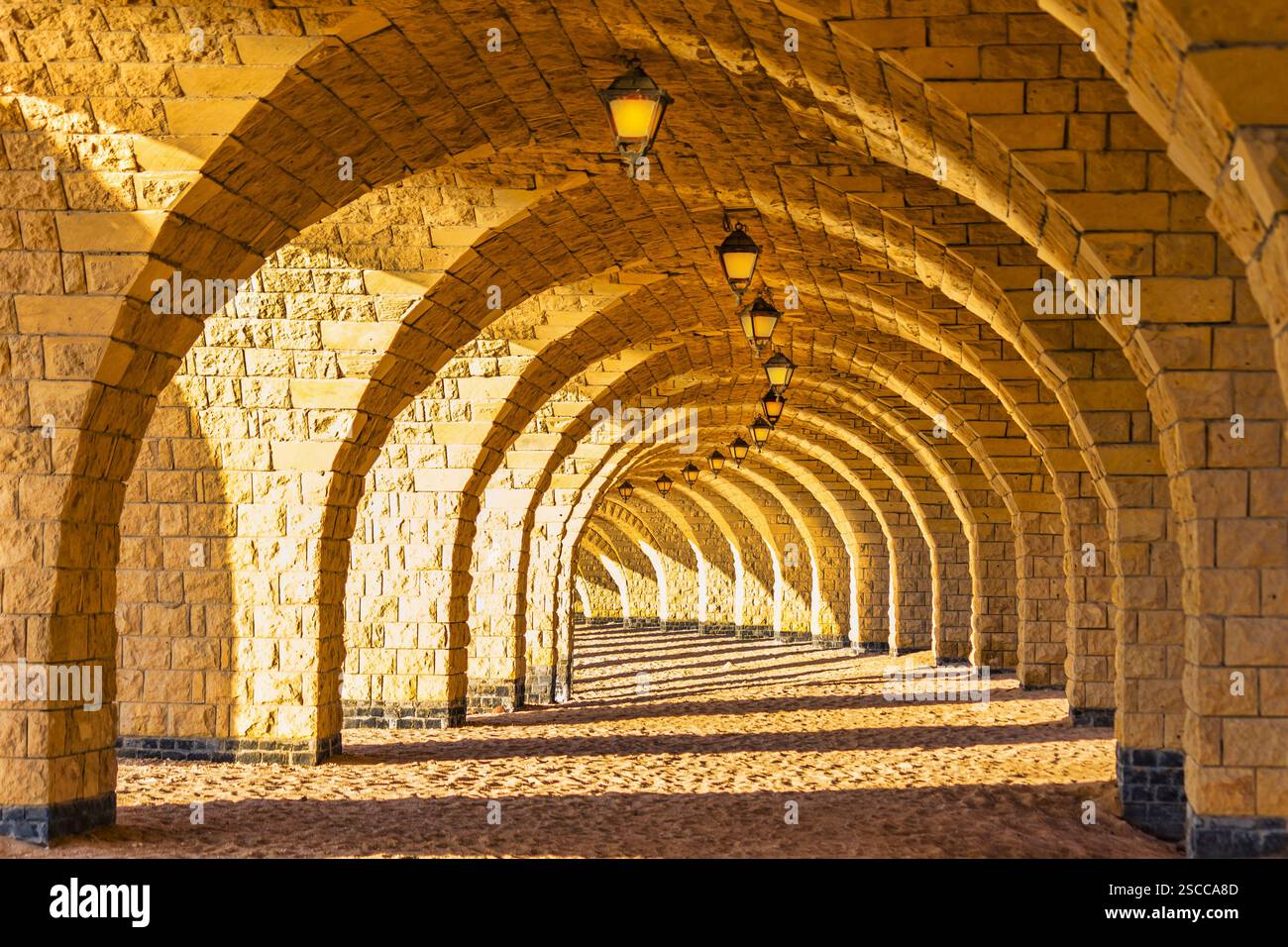 The arched stone colonnade with suspended lanterns Stock Photo - Alamy