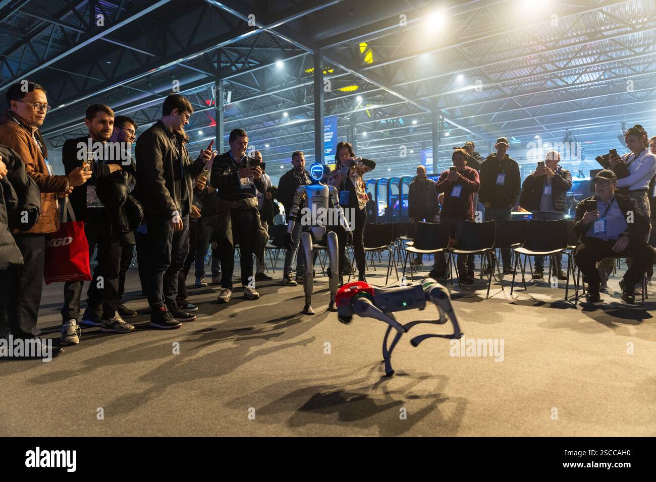 ISE 2025 (Integrated Systems Europe). Attendees taking photos to the two robots, the Humanoid ...