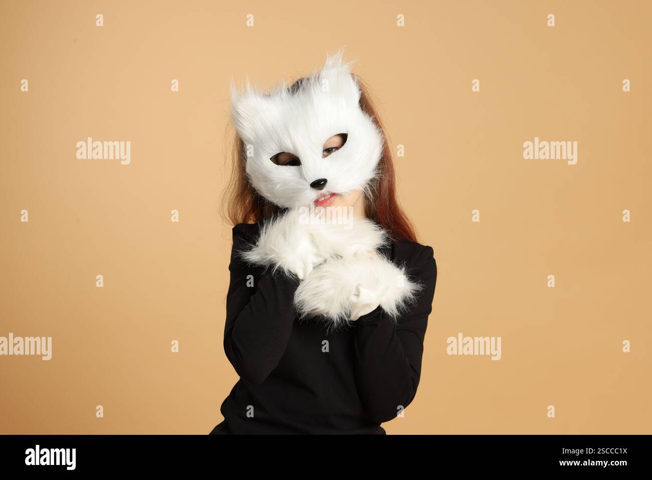 Quadrobics. Girl wearing cat mask and gloves on beige background Stock ...
