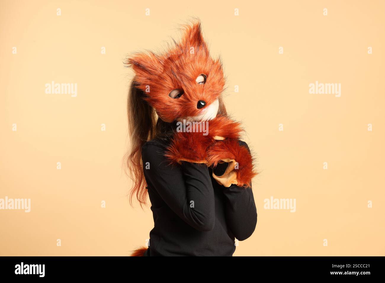 Quadrobics. Girl wearing fox mask and gloves on beige background Stock ...