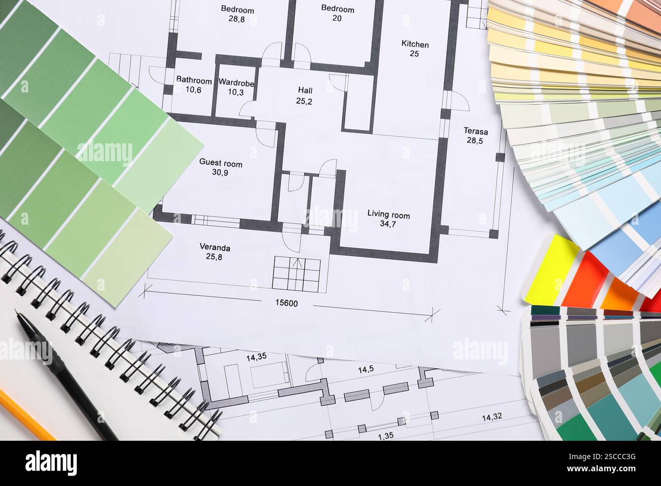 House plans, color selection charts and notebook on table, flat lay ...