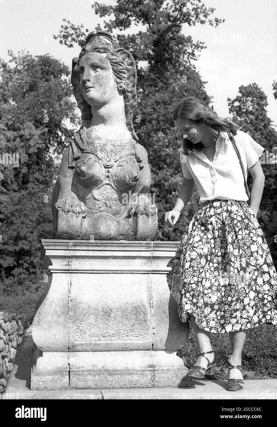 A young woman posing at a statue near Rheinsberg Castle, 1979 ...
