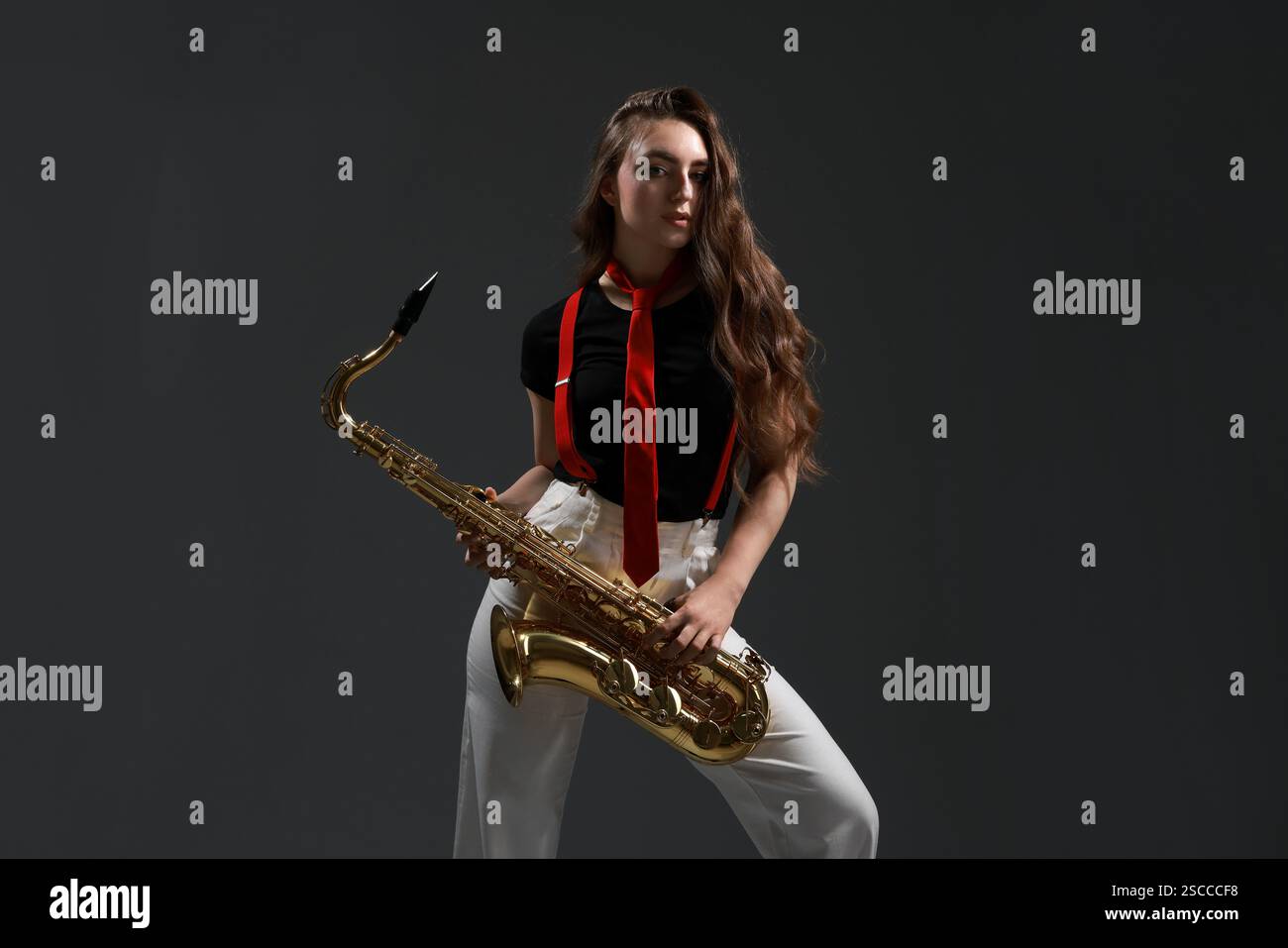 Professional musician with saxophone on grey background Stock Photo - Alamy