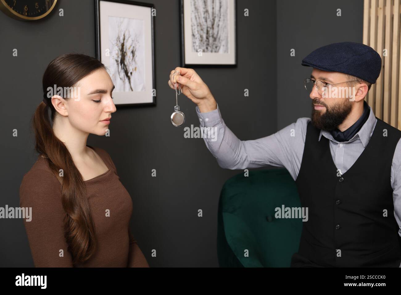 Psychologist using vintage pocket watch while working with patient ...