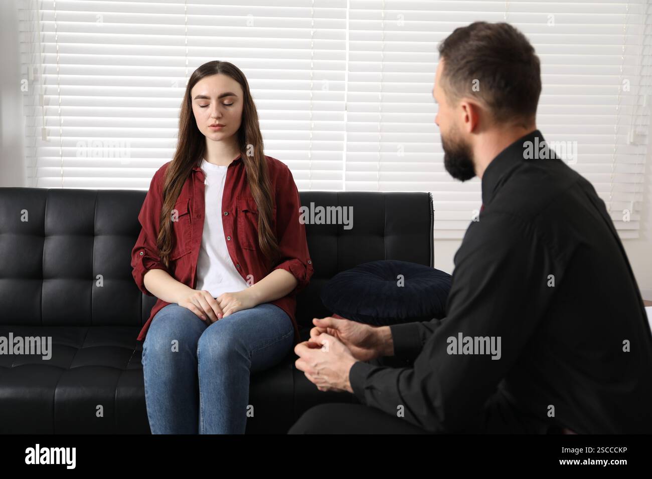 Psychologist working with patient during hypnosis session indoors Stock ...