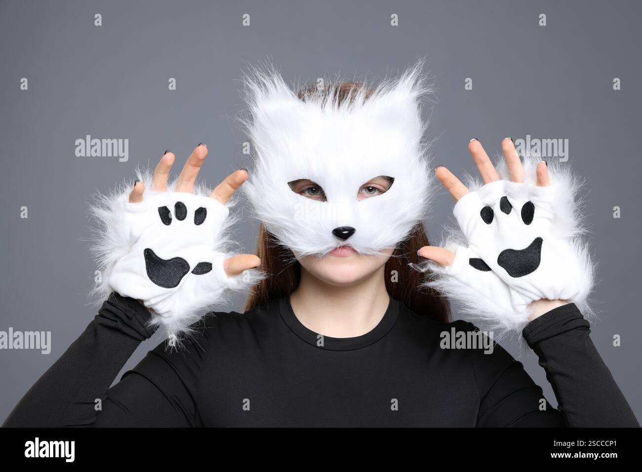 Quadrobics. Girl wearing cat mask and gloves on grey background Stock ...