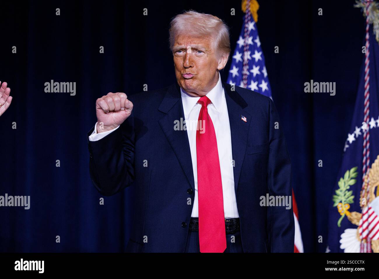President Donald Trump gives a fist bump as he arrives at the National ...