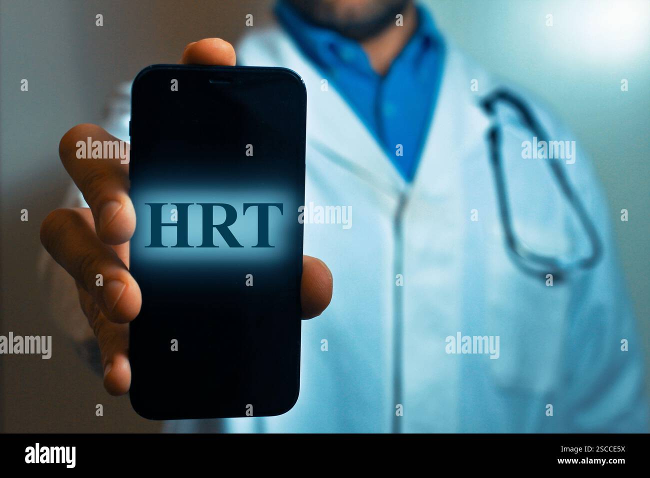 Doctor wearing uniform showing a cellphone screen with the letters "HRT ...