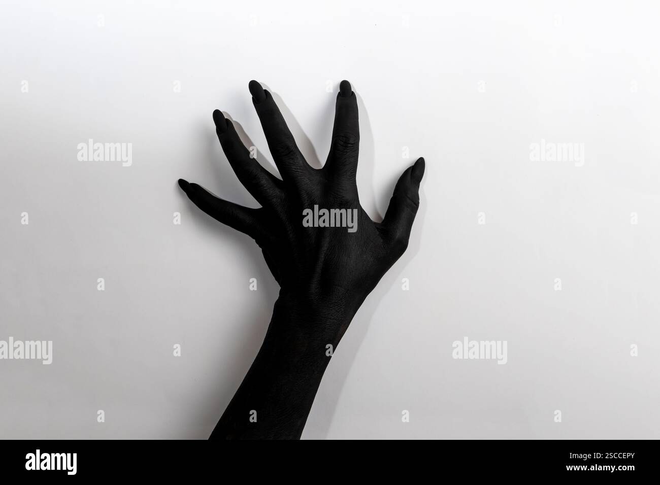 The black hand with long nails. Concept photo with woman hand painted ...