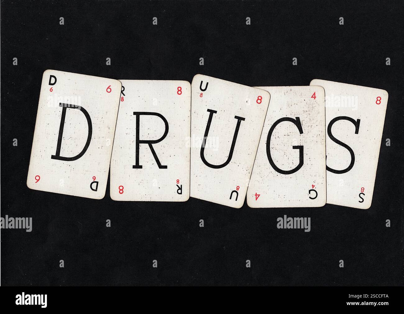 Vintage word game playing cards spelling DRUGS isolated on a black ...