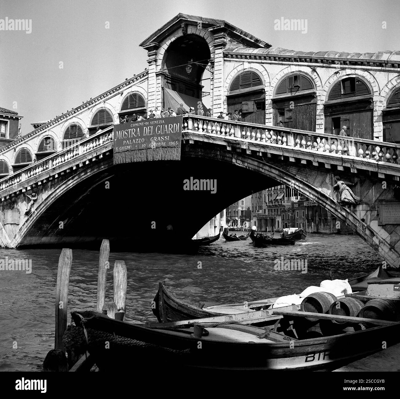 Canal and gondolas in Venice and in the back the Rialto Bridge with ...