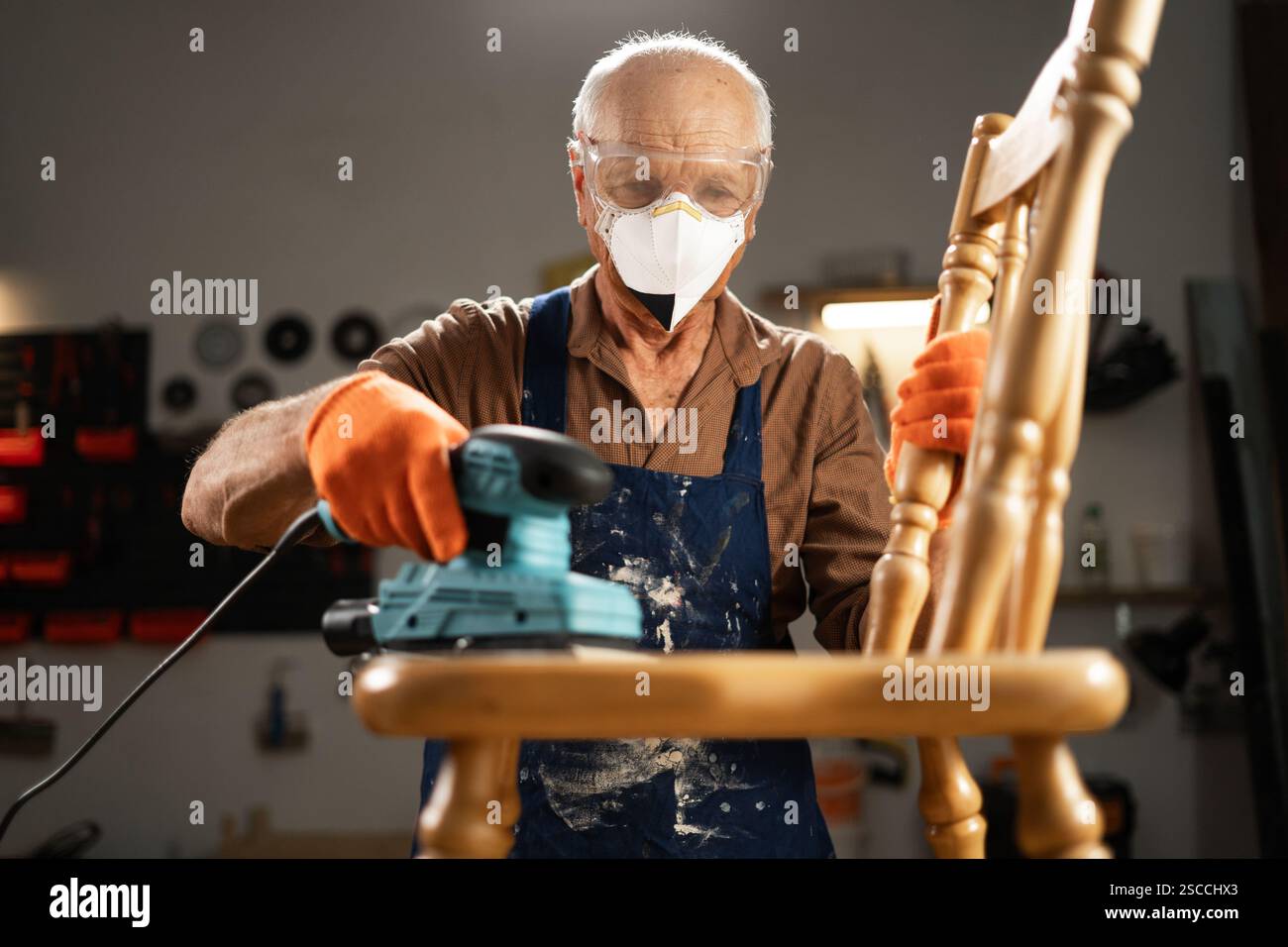 Elderly male carpenter grinding wood hi-res stock photography and ...