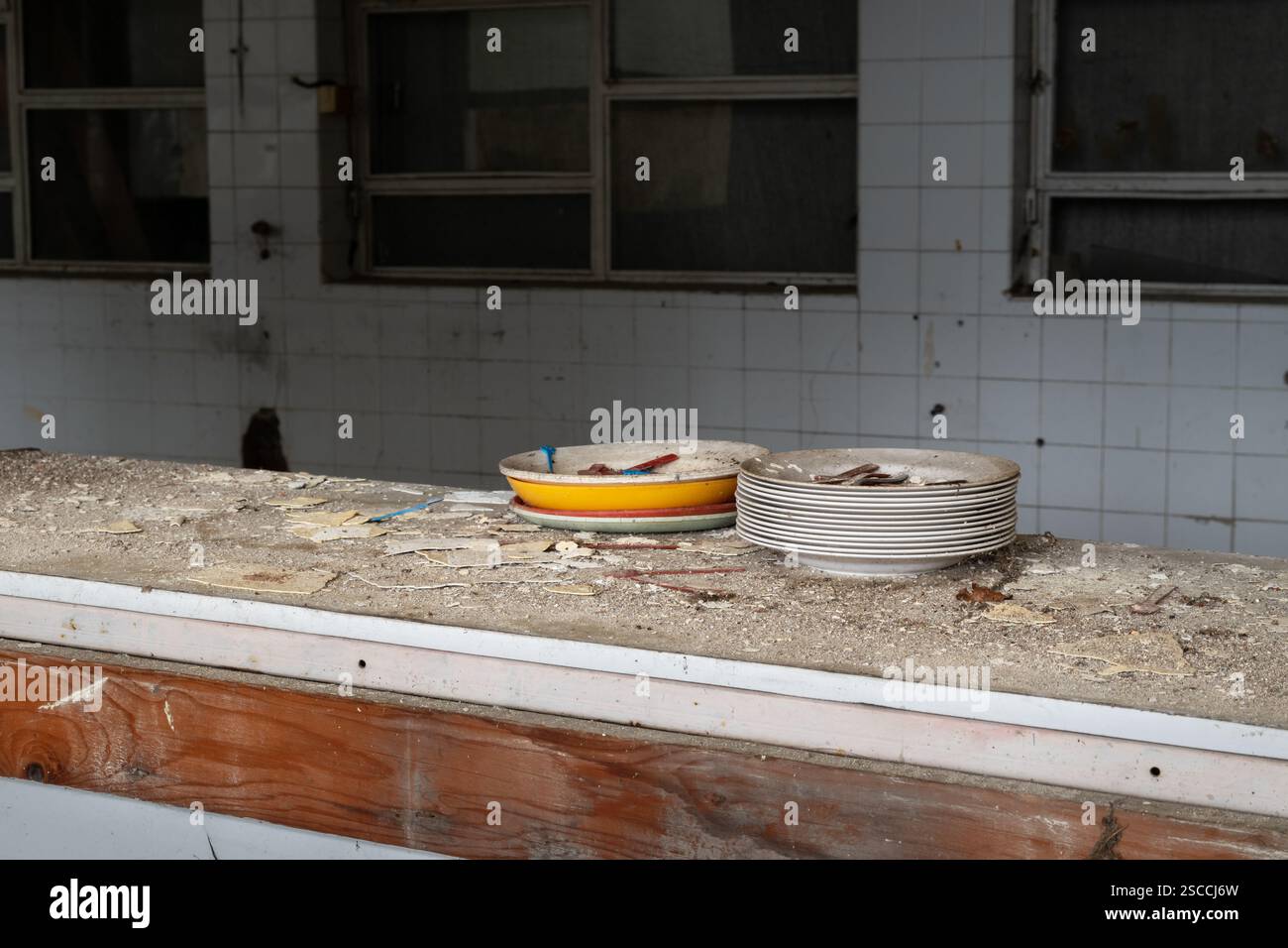 Plates with cutlery on dirty bar, abandoned canteen Stock Photo - Alamy
