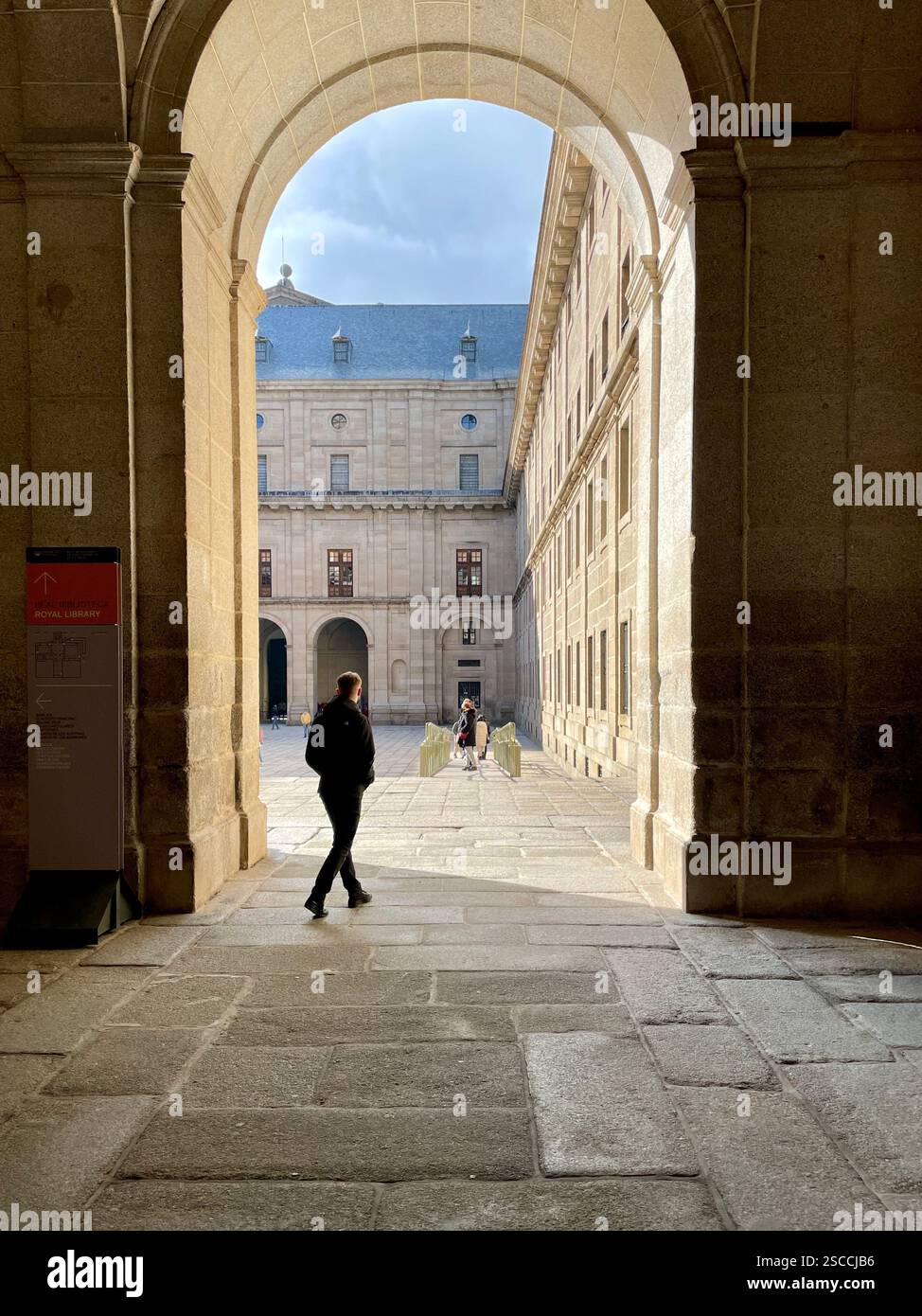 A visitor passes through a magnificent arch within the grounds of the ...