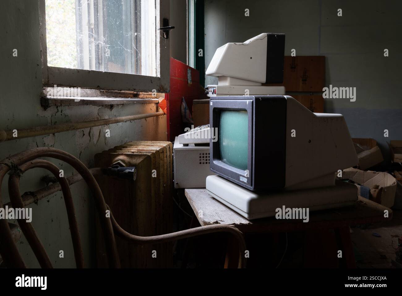 Old fashioned computer in messy warehouse Stock Photo - Alamy