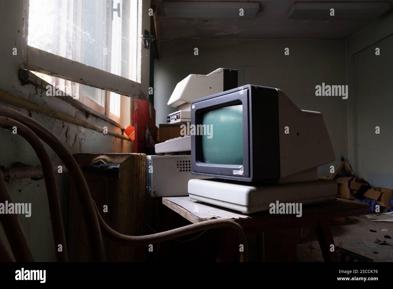 Old fashioned computer in messy warehouse Stock Photo - Alamy