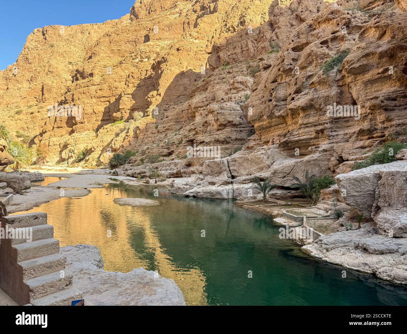 Natural oasis in Oman rocky canyon with crystal-clear green water ...