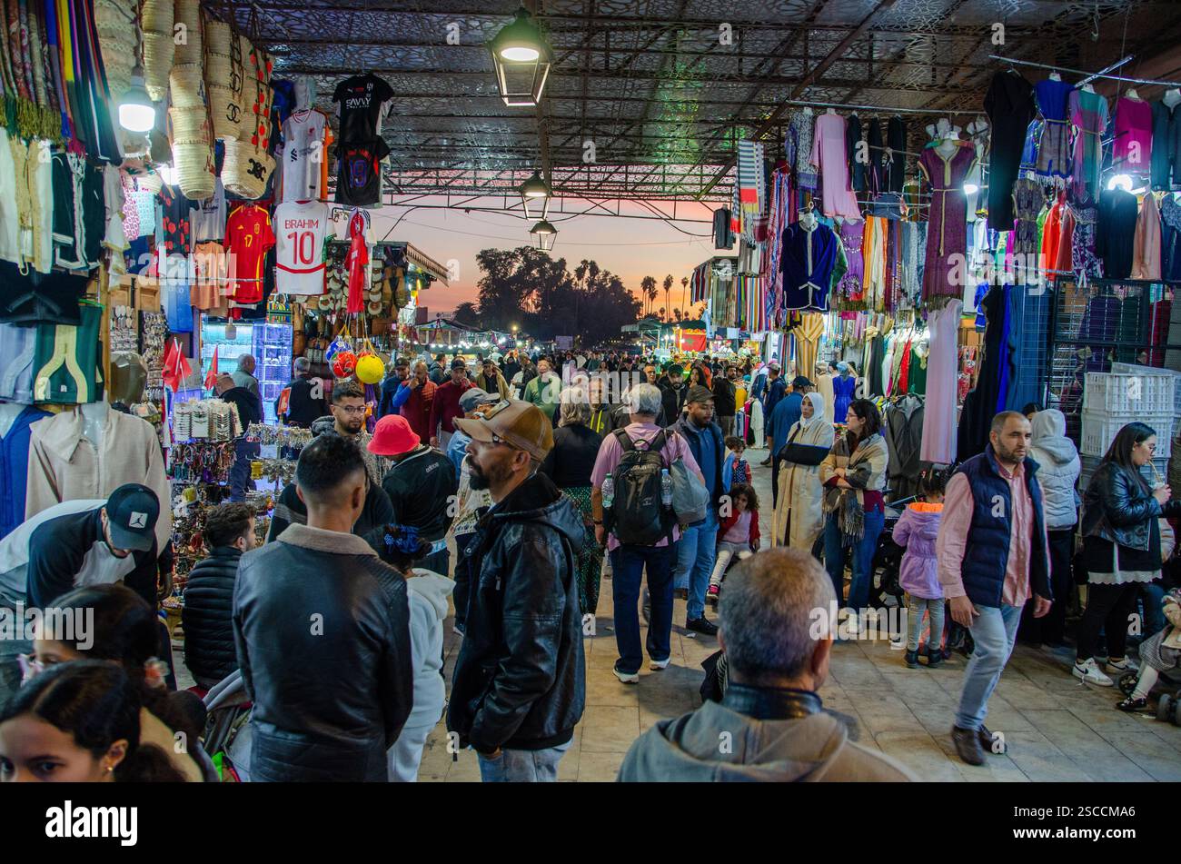 Busy market stalls in the souks around Jemaa el-Fnaa square at sunset ...