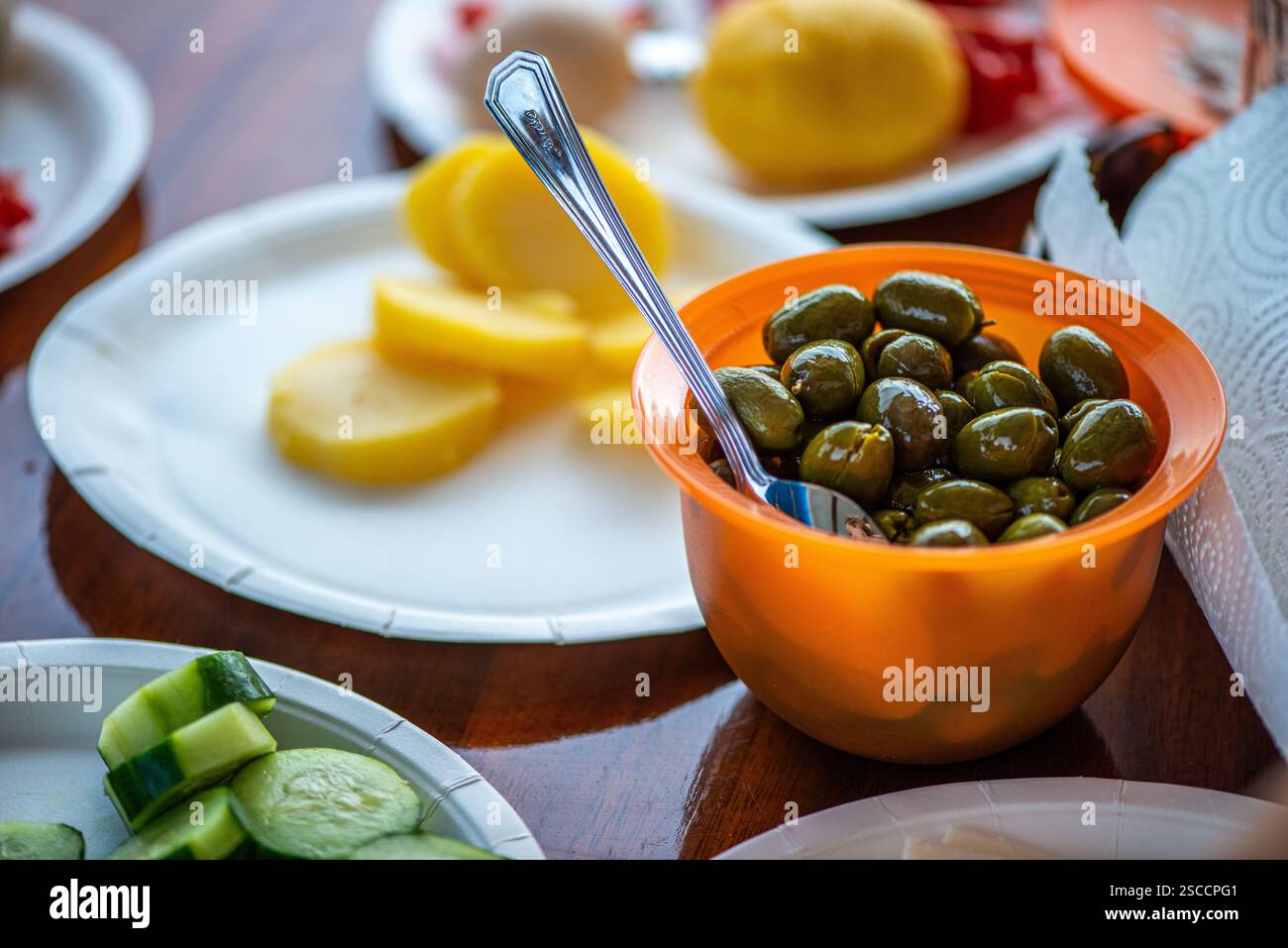A lively breakfast scene on a ship’s deck, featuring a spread of fresh ...