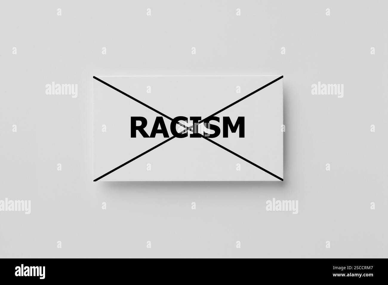 Stop racism concept. Note with crossed-out word on white background ...