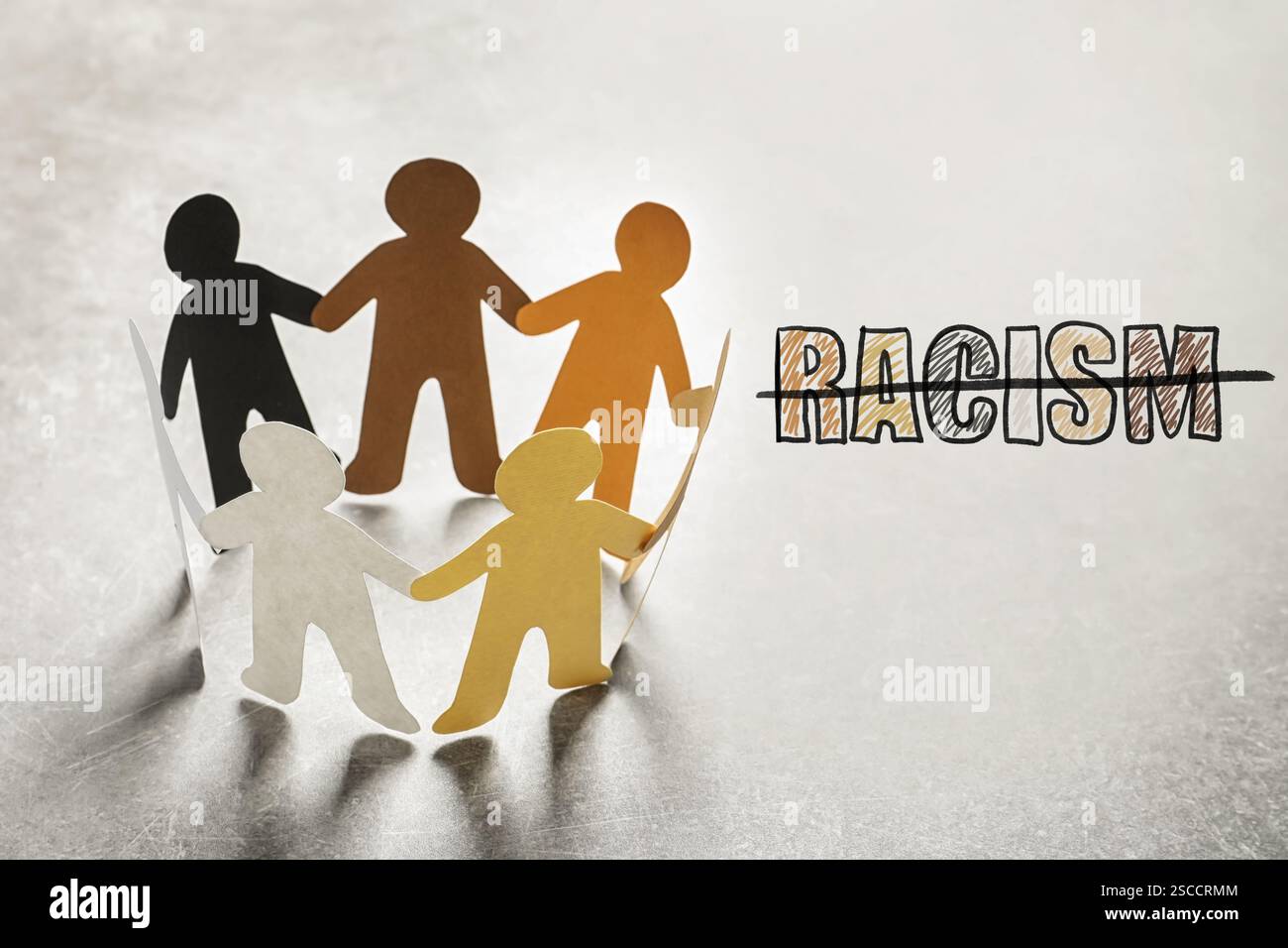 Stop racism. Paper people in different colors holding hands and ...