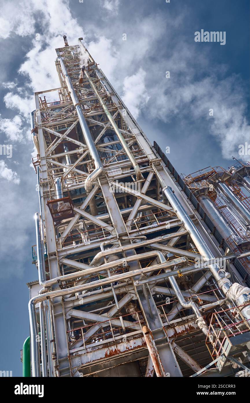 A detailed view of a chemical plant's tall structure under a clear blue ...