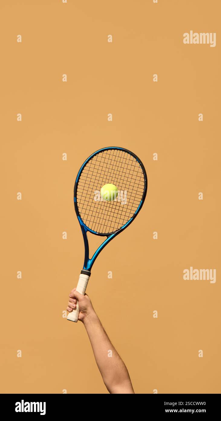 Hand gripping tennis racket, yellow ball appearing mid-air, symbolizing ...