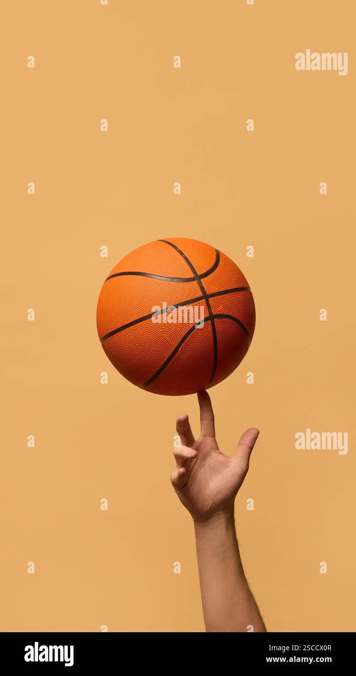 Hand balancing basketball on fingertip, showcasing skill, coordination ...