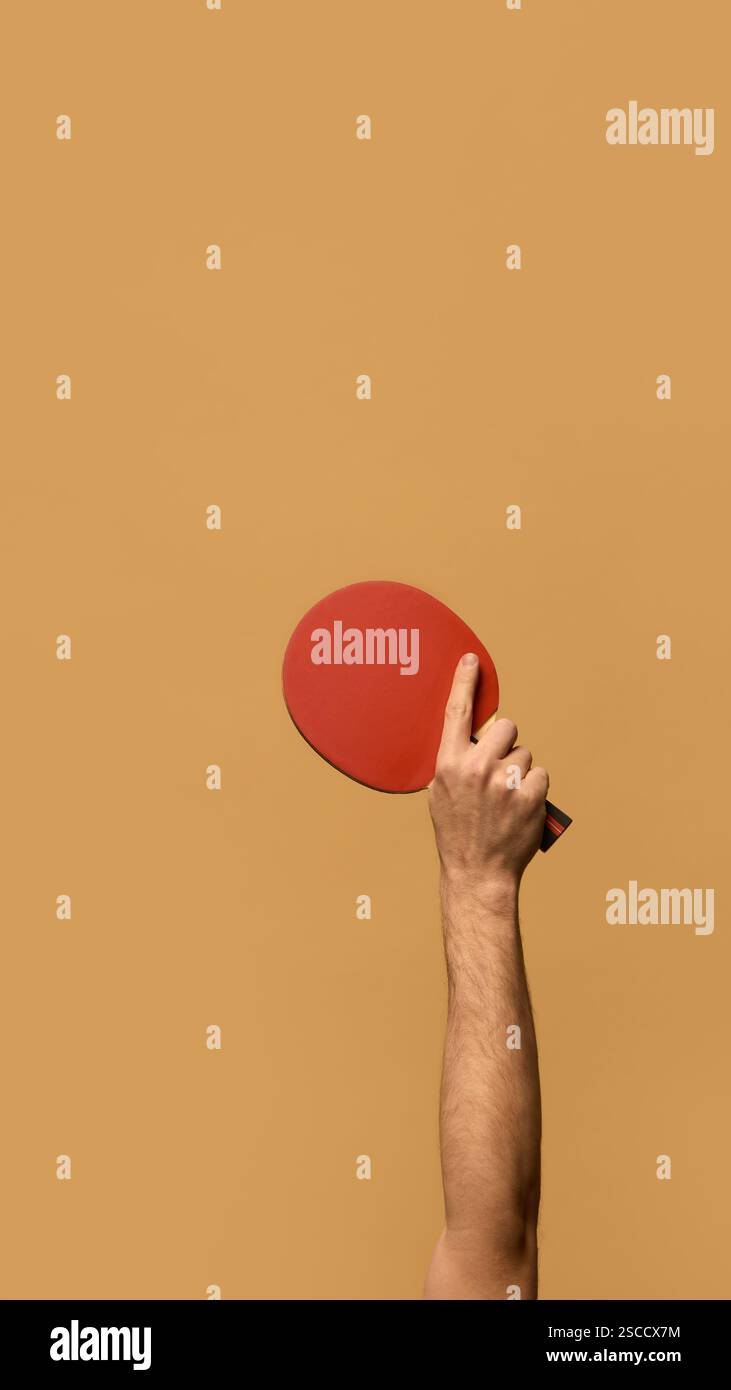 Hand raising red table tennis paddle with index finger extended ...