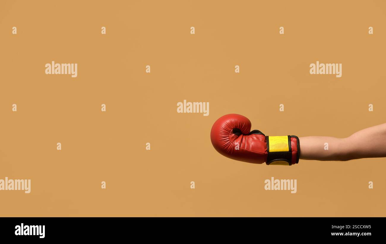 Arm extended with red boxing glove, fist clenched and slightly angled ...
