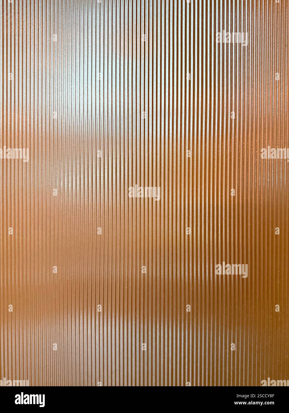 Texture of matt golden bronze fluted glass, or striped glass. Fluted ...