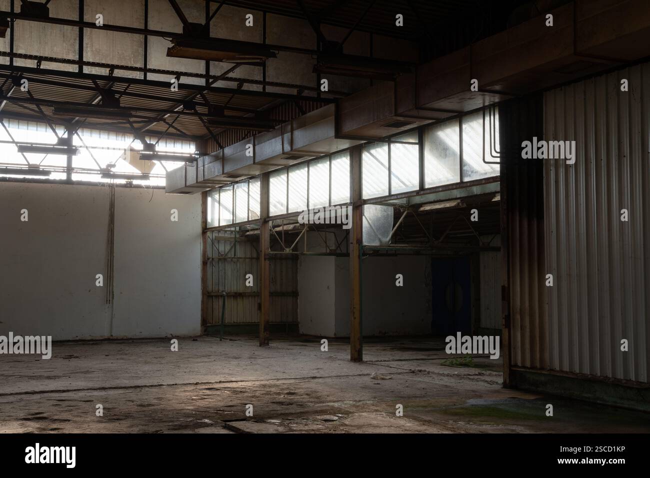 Interior of abandoned empty industry hall made of metal sheets and ...
