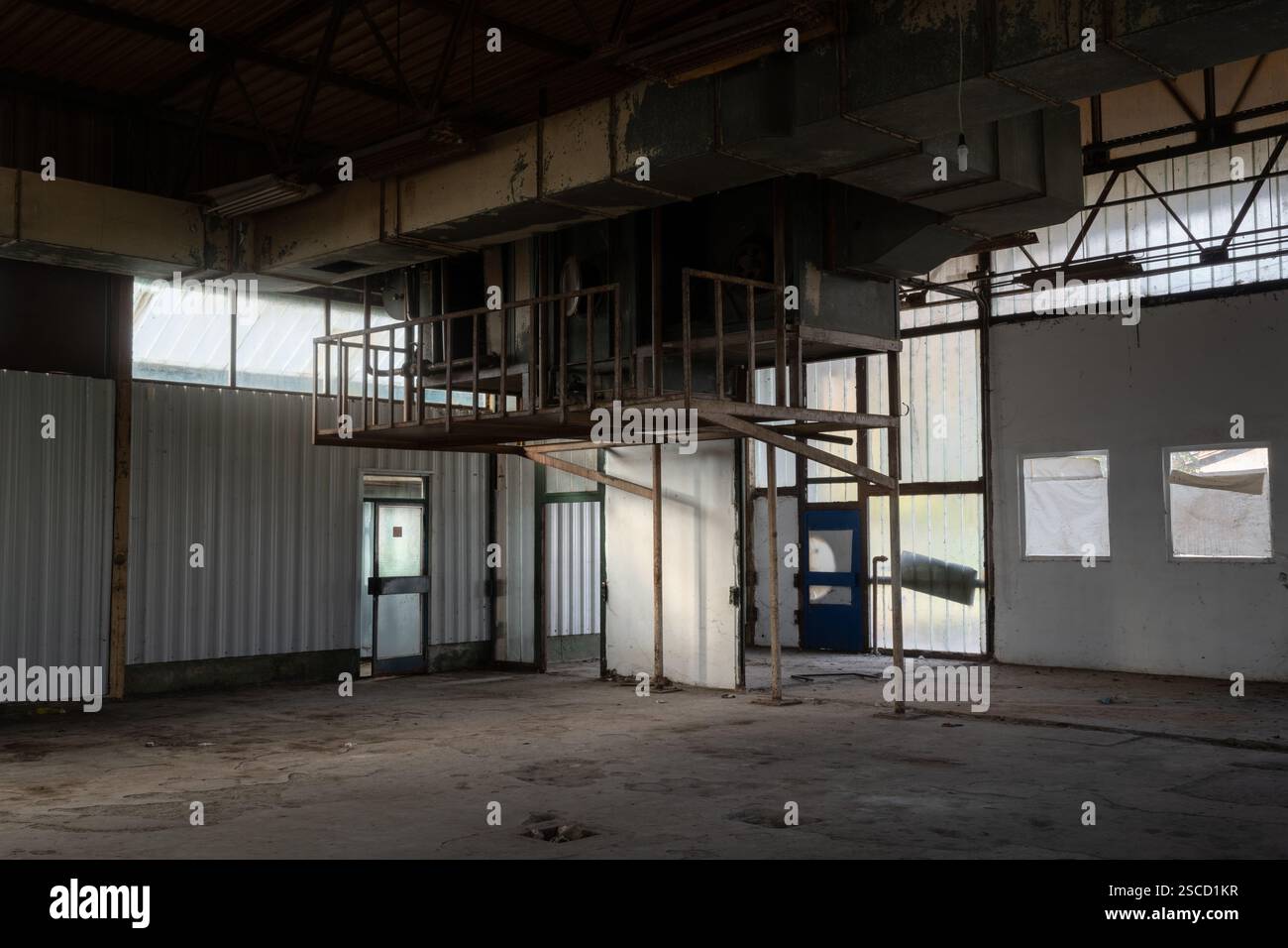 Interior of abandoned empty industry hall made of metal sheets and ...