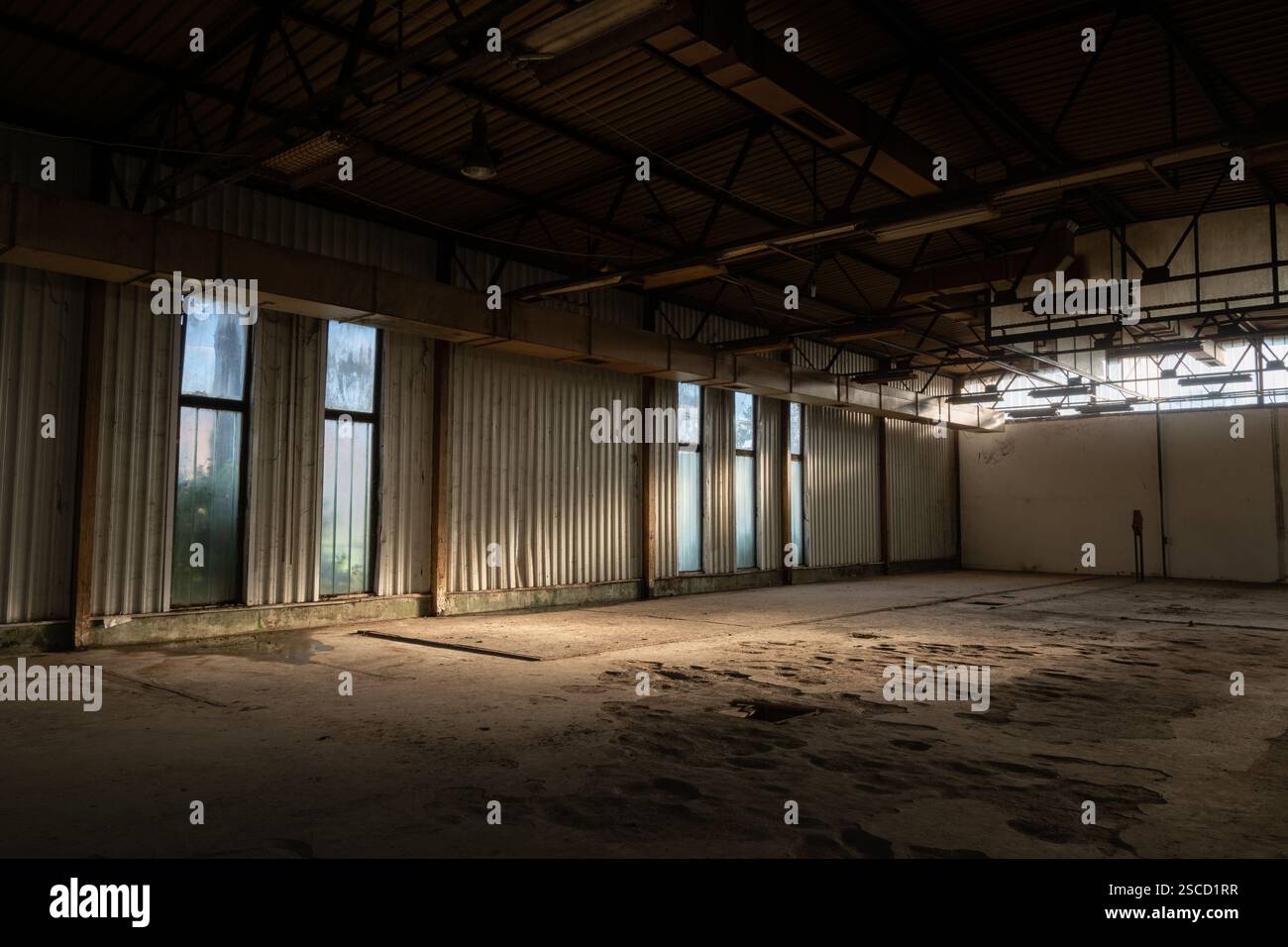 Interior of abandoned empty industry hall made of metal sheets and ...