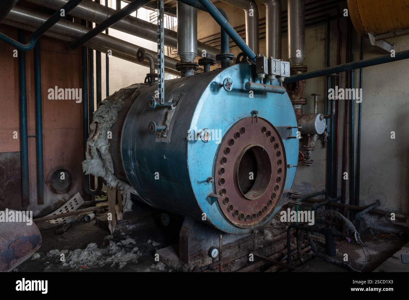 Broken heating furnace on fossil fuel in abandoned industrial building ...