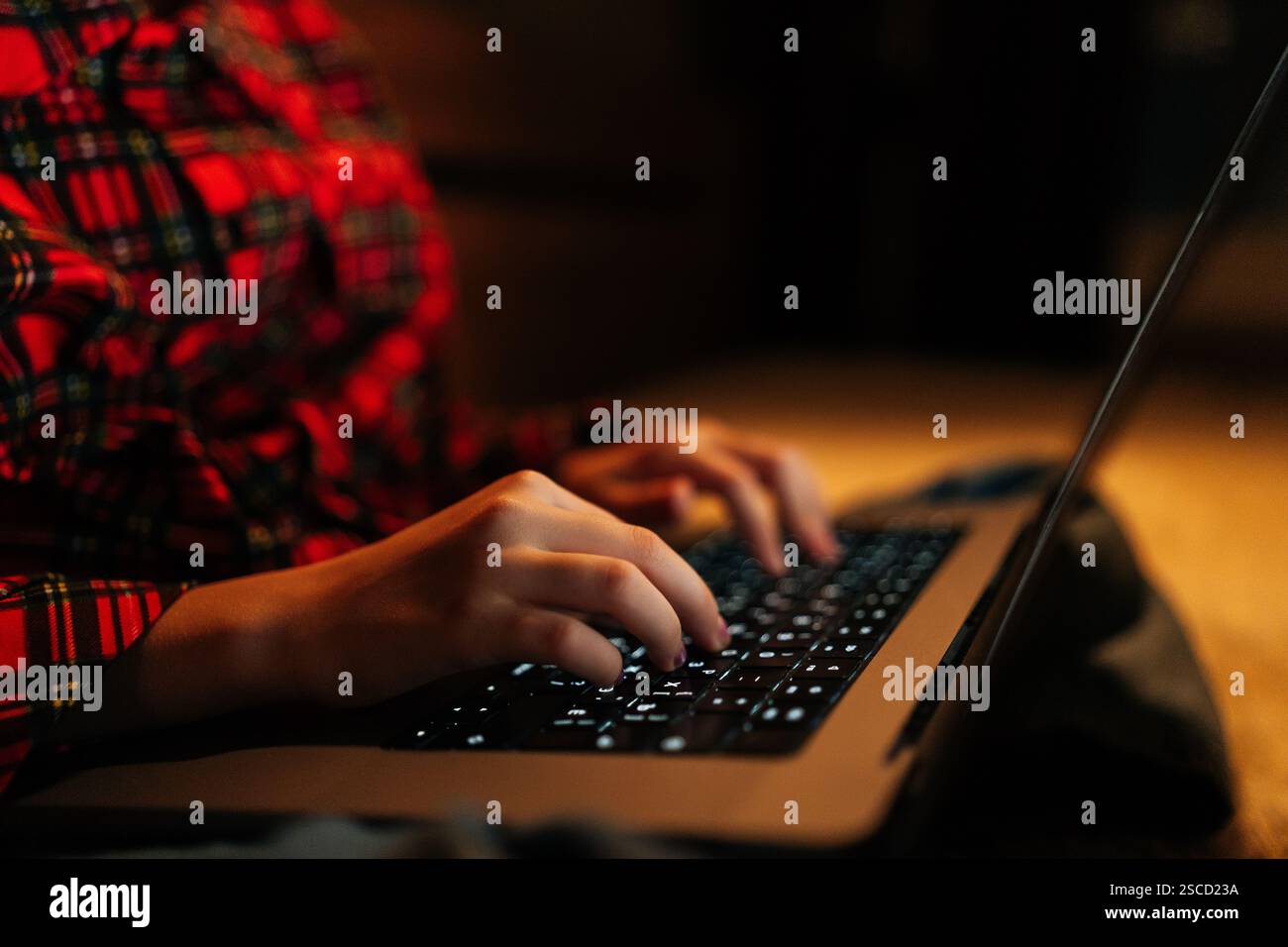 Close-up hands of unrecognizable teen girl wearing red and black ...